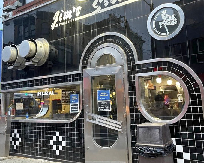 The iconic black and white tiled exterior of Jim's South St. stands like a cheesesteak beacon on Philadelphia's bustling South Street, promising sandwich salvation to all who enter.