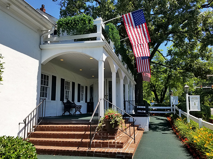 The colonial charm of William Penn Inn welcomes you with its pristine white facade, black shutters, and those cheerful pineapple flags&mdash;hospitality's universal symbol since before Instagram made food photos a sport.