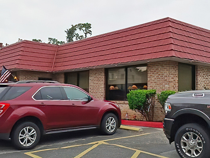 The classic red-tiled roof and American flags announce this culinary treasure like a delicious secret hiding in plain sight.