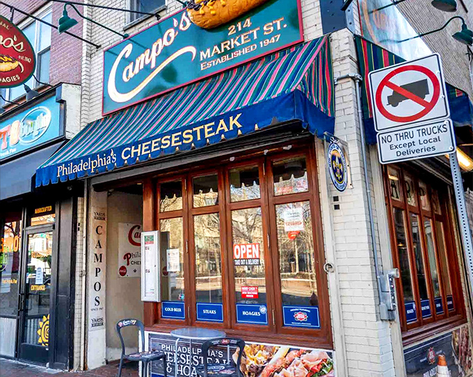 Campo's iconic storefront beckons with its giant cheesesteak sign &ndash; like a meaty lighthouse guiding hungry souls through Philadelphia's historic streets.