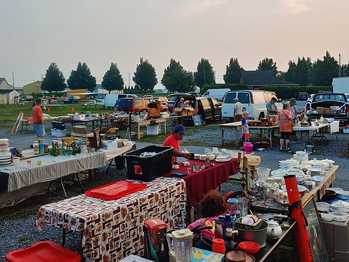 The bustling heart of Root's Old Mill Flea Market, where treasure hunters navigate a sea of possibilities under white canopy tents.