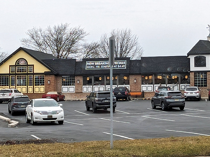 The yellow and brick facade of Limerick Diner stands like a beacon of breakfast hope against the Pennsylvania sky, promising culinary comfort to all who enter.