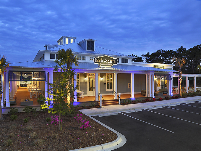 The coastal charm hits you before the first bite. Hook & Barrel's white clapboard exterior and welcoming porch practically whisper "seafood paradise awaits."