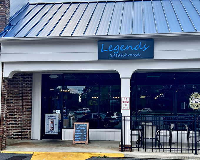 The blue sign beckons like a lighthouse for hungry souls. Legends Steakhouse's modest exterior hides culinary treasures within. 