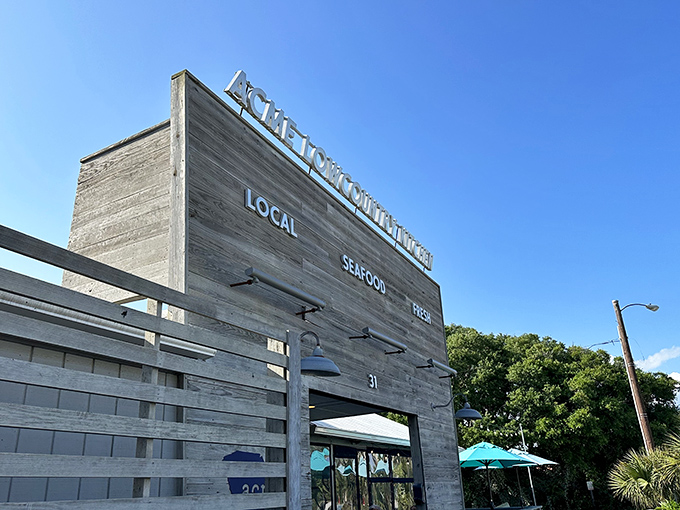 The weathered wooden facade of Acme Lowcountry Kitchen promises exactly what the sign delivers: local, fresh seafood without pretense or fuss.