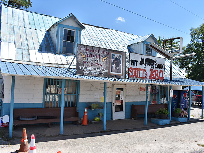 The weathered metal roof and humble blue trim might not scream "culinary destination," but that "PIT COOK" sign tells the real story. BBQ pilgrimage begins here.