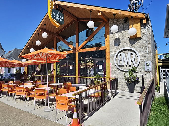 The stone and timber exterior of Butter Milk Ranch beckons like a modern-day siren, those orange chairs practically shouting "sit here and stay awhile!"