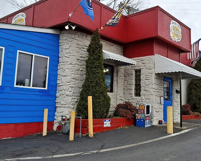 The red and blue exterior of Gabby's stands like a colorful beacon for burger enthusiasts. No fancy architecture needed when what's inside tastes this good.