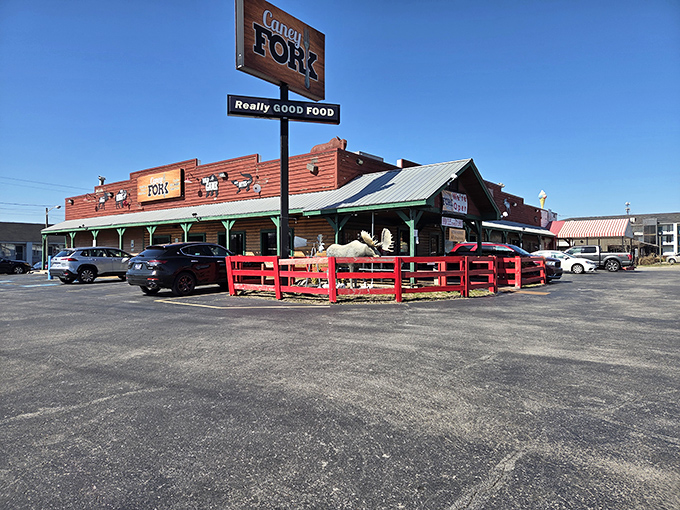 The rustic wooden exterior of Caney Fork beckons with its "Really GOOD FOOD" promise and distinctive red fence &ndash; like a frontier outpost for hungry explorers.