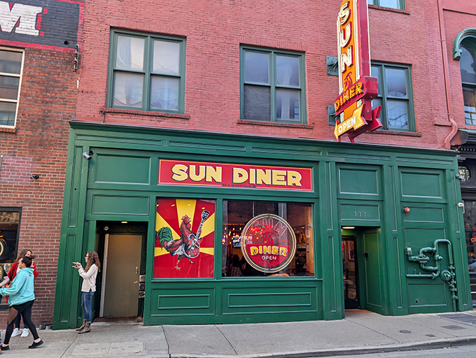 The emerald-green storefront of Sun Diner stands out like a jewel in downtown Nashville, beckoning hungry travelers with its vibrant rooster logo and retro charm.