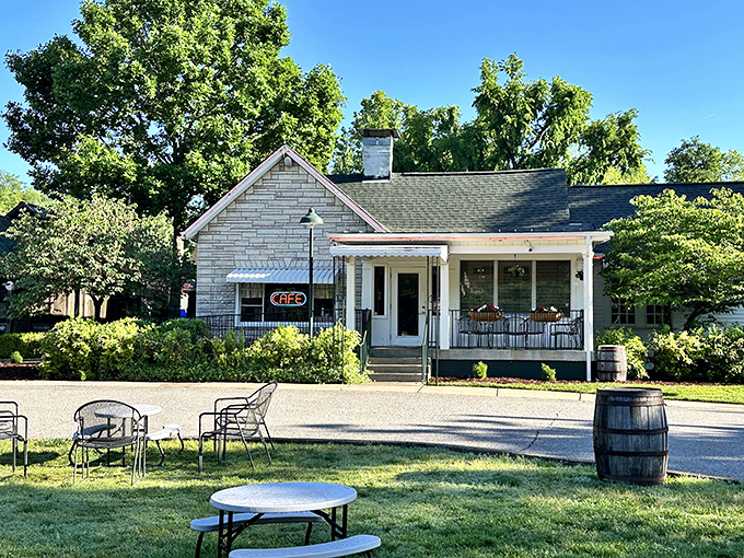 The neon "CAFE" sign glows like a beacon of culinary hope, promising Southern comfort behind those stone walls and checkered curtains.