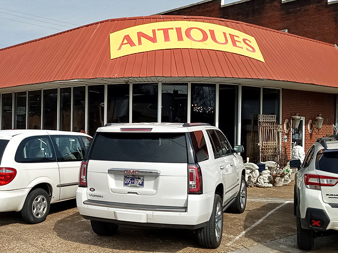 The distinctive red-roofed exterior with its bold yellow "ANTIQUE" sign practically screams, "Come in, we have cool stuff you didn't know you needed!"