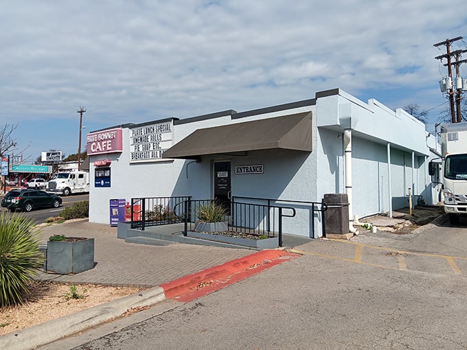 The unassuming exterior of Blue Bonnet Cafe stands like a beacon of hope for hungry travelers. That "Pie Happy Hour" sign is basically a bat signal for dessert enthusiasts.