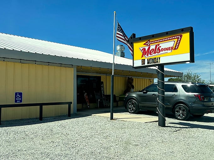 The bright yellow exterior of Mel's Diner stands like a beacon of hope for hungry travelers on the Texas highway. That classic sign promises comfort food salvation ahead.