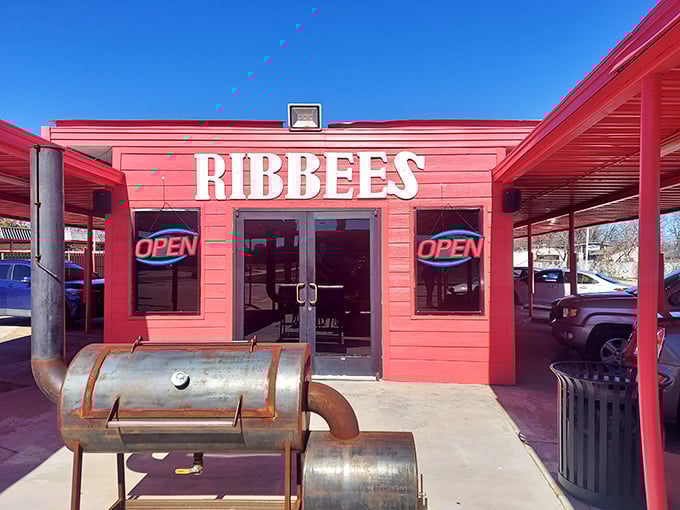 The bright red exterior of Ribbee's isn't subtle &ndash; it's like Texas itself, boldly announcing "serious barbecue happens here" with its weathered smoker standing guard.