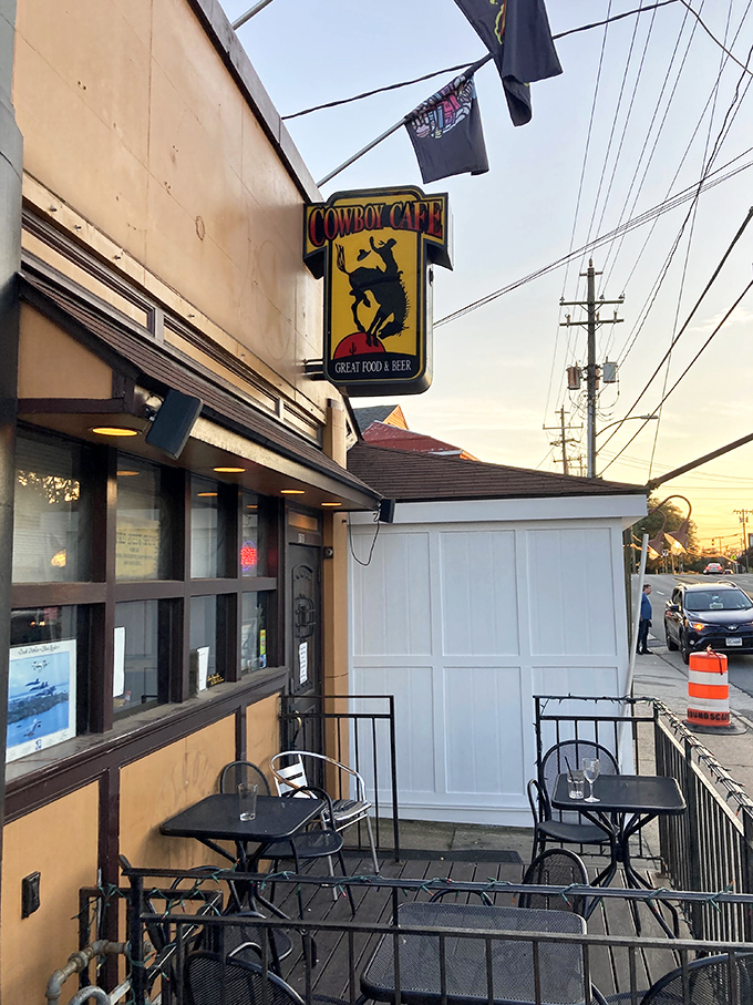 Street art meets comfort food at Cowboy Cafe's vibrant exterior. The colorful mural and wooden steps invite you into Arlington's hidden gem.