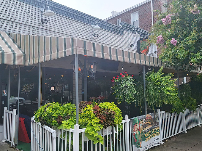 Kelly's welcoming exterior beckons with its classic striped awning and lush greenery. The patio seating offers a perfect perch for people-watching while savoring their famous fare.