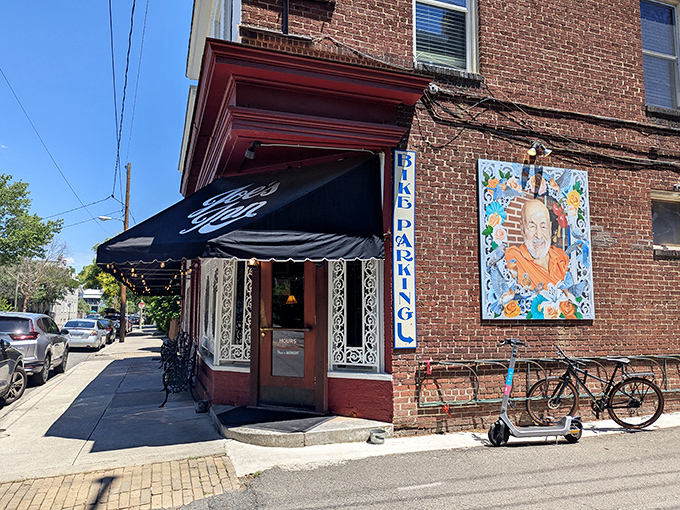 The iconic red brick exterior of Joe's Inn beckons like an old friend, complete with charming black awning and ornate window frames that whisper "come on in."
