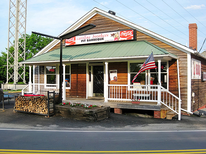 The barbecue beacon of Ashburn! This rustic wooden haven with its American flag and woodpile promises smoky delights before you even step inside.