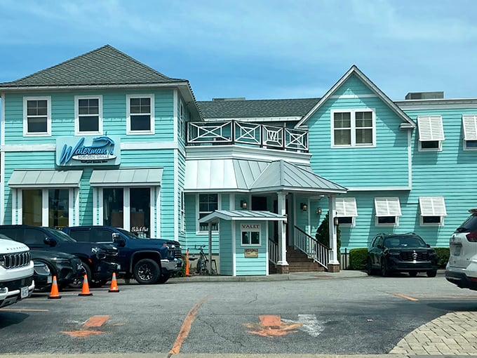 The aqua-colored exterior of Waterman's stands like a coastal beacon, promising seafood treasures within its unassuming beach house façade.