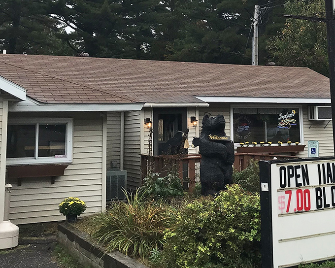 The guardian of good taste! A wooden black bear welcomes hungry travelers to this unassuming Northwoods gem where culinary treasures await.