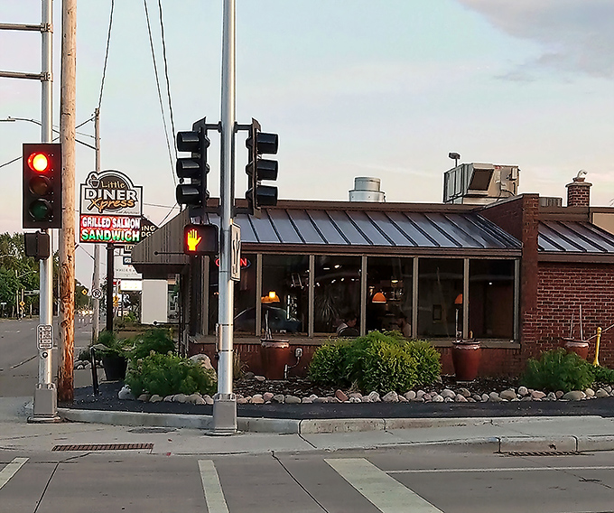 The corner brick building with its vintage "GRILLED HAM SANDWICH" sign stands like a breakfast lighthouse guiding hungry souls through Appleton's morning fog.