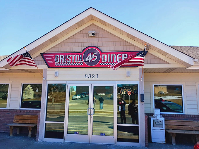 The Bristol 45 Diner's exterior promises a time-travel experience with its classic signage and American flags. Wisconsin's answer to nostalgic dining beckons from Highway 45.