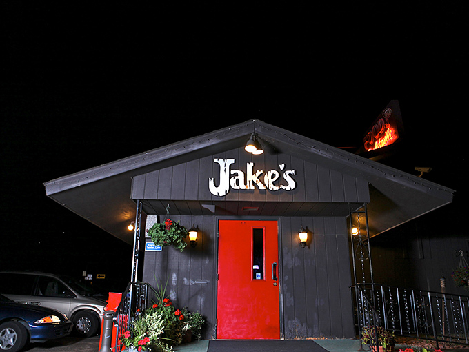 That iconic red door against the dark exterior practically screams "good times ahead" – Jake's welcoming façade sets the perfect Wisconsin supper club tone.
