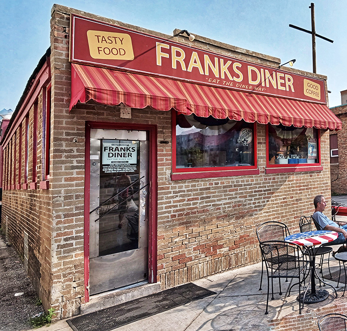 That red brick facade with the striped awning whispers "authentic diner magic" before you even step inside.