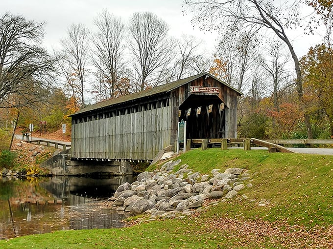 Time stands still at Fallasburg Covered Bridge, where weathered gray boards have witnessed Michigan history unfold for nearly 150 years, spanning the peaceful Flat River.