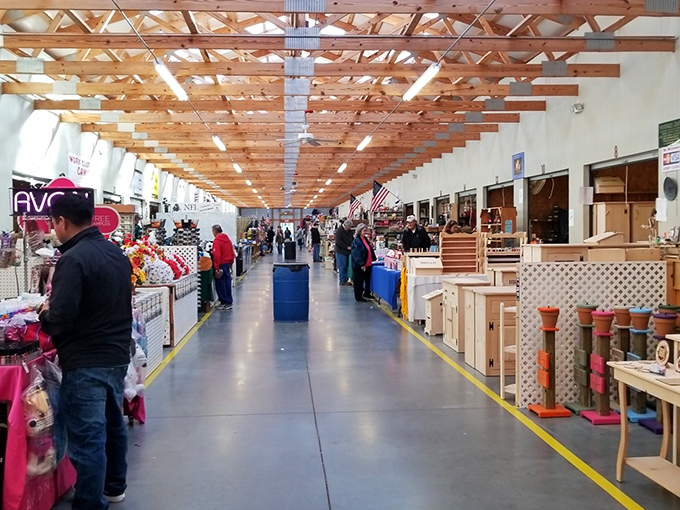 The covered walkways of Webb Road Flea Market stretch like a runway for bargain hunters, where treasures await under rustic wooden beams.