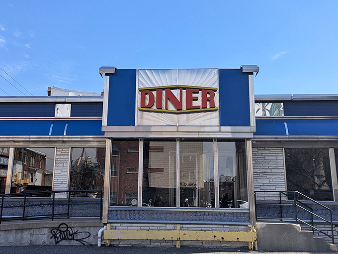 That iconic blue facade with the bold "DINER" sign isn't just a restaurant entrance&mdash;it's a portal to comfort food paradise.