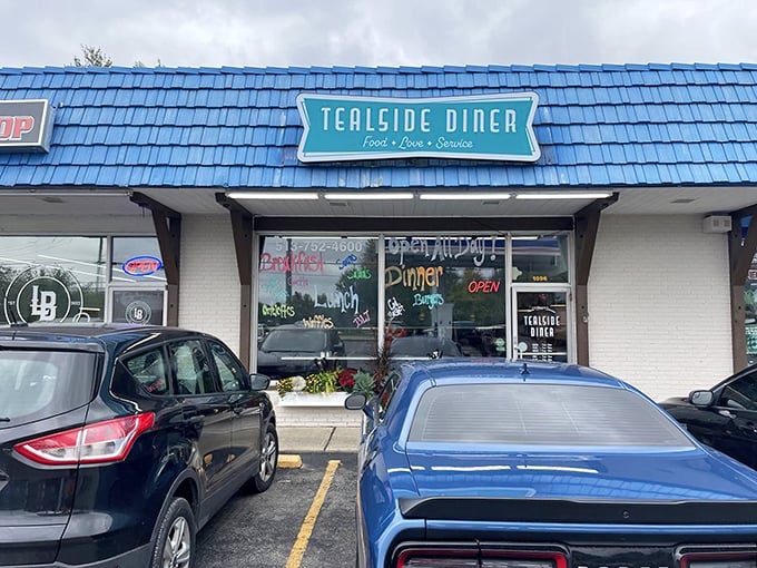 The blue roof of Tealside Diner stands out like a beacon of breakfast hope. This unassuming strip mall gem promises culinary treasures within.