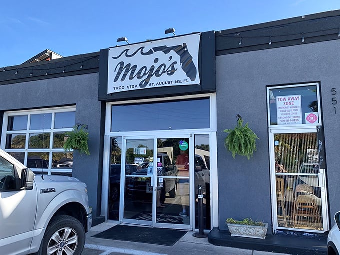 The unassuming exterior of Mojo's Tacos stands like a flavor fortress in St. Augustine, promising culinary treasures behind that simple "TACOS" sign.