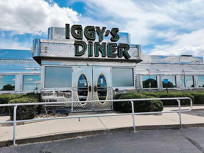 The gleaming stainless steel exterior of Iggy's Diner shines like a time capsule from 1955, beckoning hungry travelers with its vintage Route 66 charm.