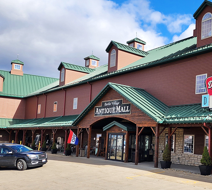 The rustic charm of Berlin Village Antique Mall beckons treasure hunters with its distinctive wooden facade and welcoming entrance, promising adventures in nostalgia inside.