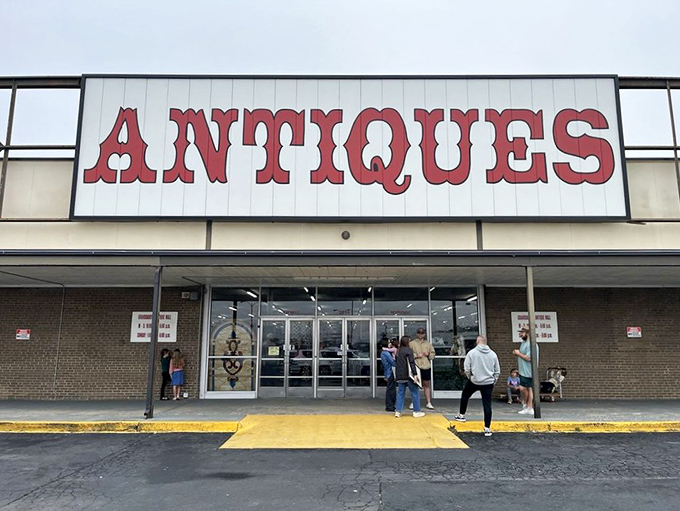 The red block letters spelling "ANTIQUES" aren't just a sign&mdash;they're a promise of treasure hunting adventures waiting just beyond those doors.