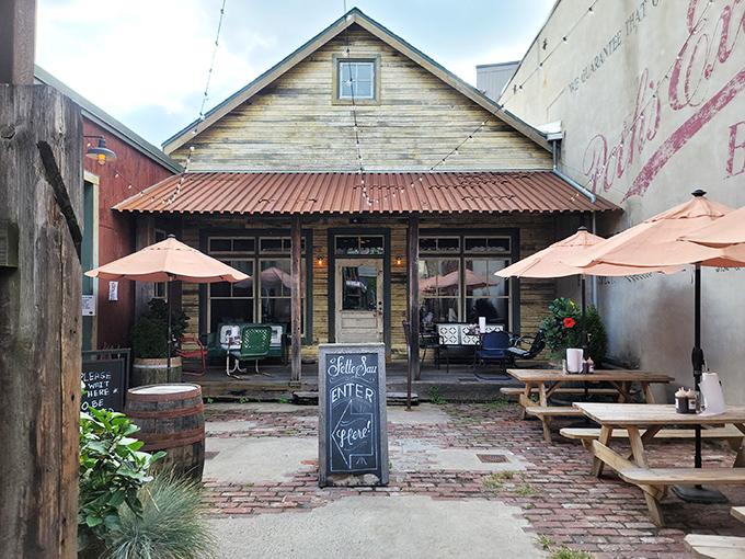 The weathered wooden exterior of Fette Sau beckons like an old friend, promising smoky treasures within its rustic walls.