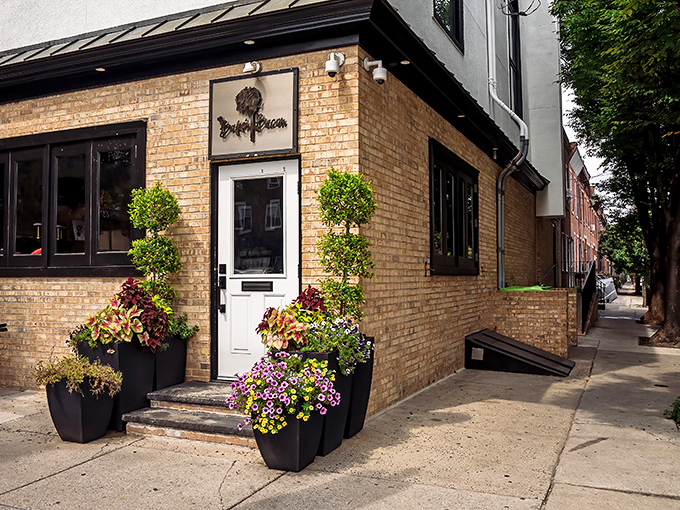The unassuming brick exterior hides Philadelphia's pork paradise like a culinary speakeasy. Those planters aren't just pretty&mdash;they're guarding the gateway to flavor town.