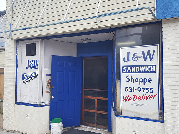 The unassuming blue door of J&W Sandwich Shoppe stands like a portal to sandwich nirvana. No fancy signage needed when the food speaks this loudly.