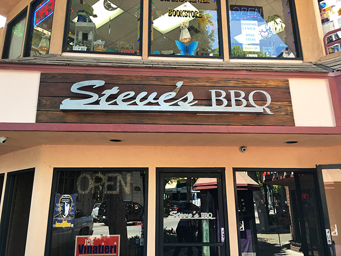 Steve's BBQ welcomes you with a cozy patio entrance that feels like the gateway to barbecue paradise. String lights and greenery create the perfect California-casual vibe.