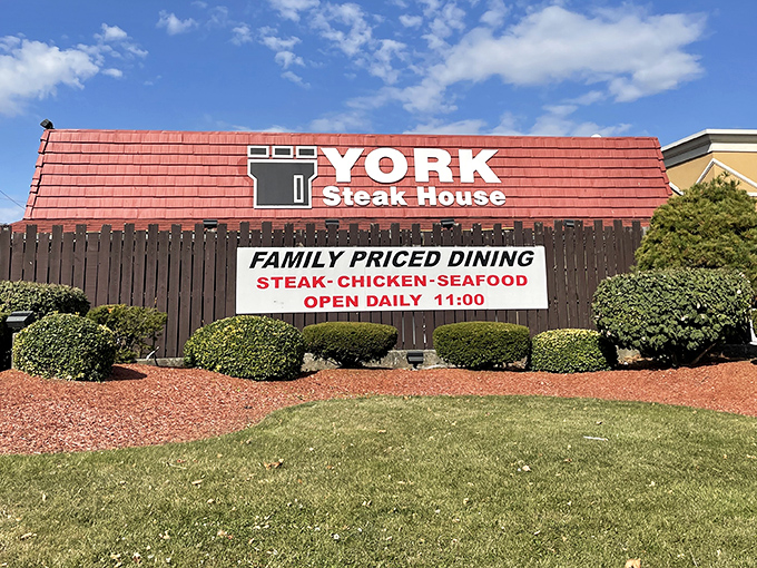 The red-roofed Tudor exterior stands like a culinary time capsule on West Broad Street, promising carnivorous delights that have satisfied Columbus diners for decades.