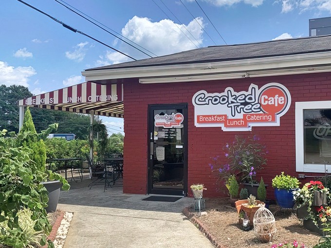 The bright red exterior of Crooked Tree Cafe beckons like a culinary lighthouse, promising breakfast salvation to weary morning travelers.