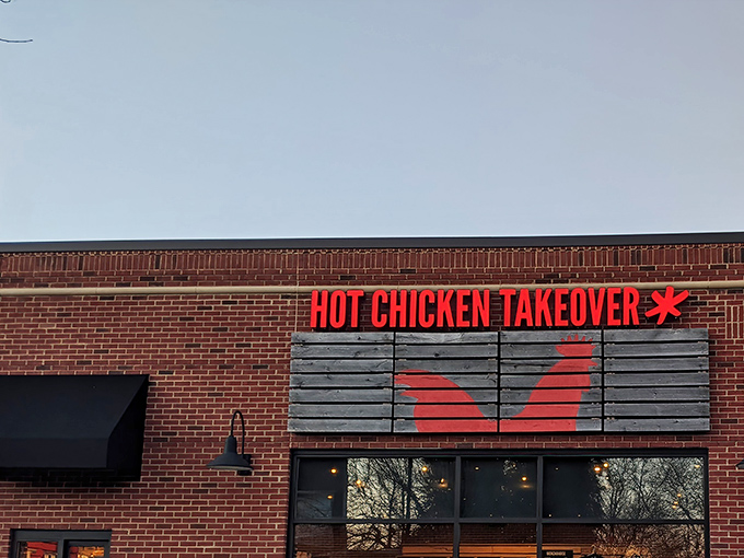 The brick fortress of flavor beckons from the street, promising Nashville heat with Midwestern hospitality inside those glass doors.