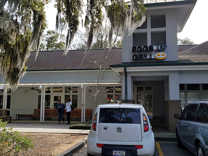 The inviting exterior of Eggs Up Grill beckons with its cheerful sign and welcoming porch &ndash; like a breakfast lighthouse guiding hungry souls to shore.
