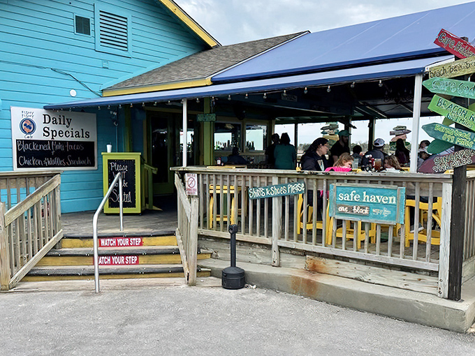 The weathered blue exterior and bright yellow bicycle perfectly capture Southport's laid-back coastal charm. Seafood paradise awaits beyond that unassuming ramp.