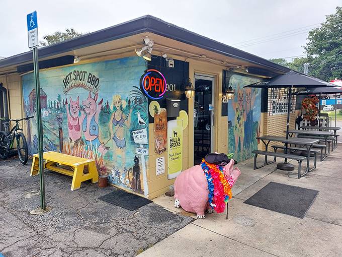 The unassuming yellow exterior of Hot Spot Barbecue, where those red umbrellas aren't just for show&mdash;they're beacons guiding hungry souls to barbecue nirvana.