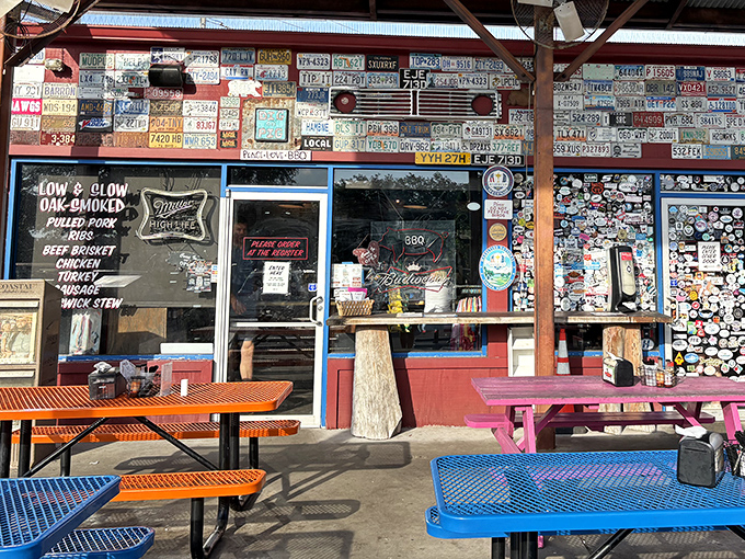 The pilgrimage begins here: colorful picnic tables, license plate-adorned walls, and that unmistakable aroma of hickory smoke that'll haunt your dreams.