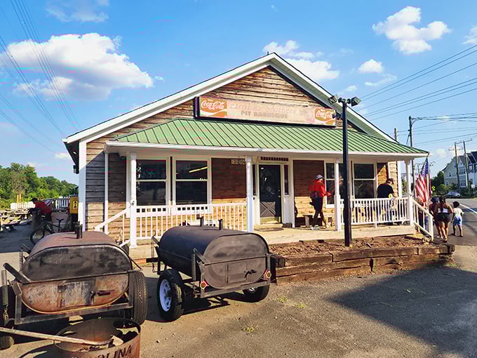 The barbecue beacon of Ashburn! This rustic wooden haven with its American flag and woodpile promises smoky delights before you even step inside.