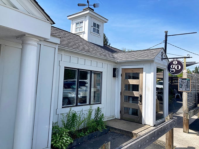 This charming white facade with its welcoming double doors practically whispers "breakfast magic happens here."